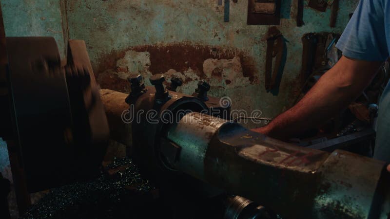 Artisan Using a Lathe Machine in a Rustic Workshop with Tools on the ...