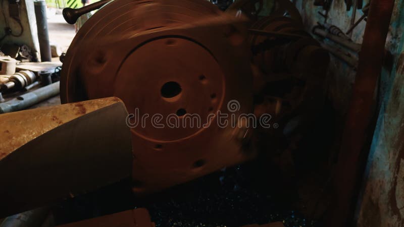 Artisan Using a Lathe Machine in a Rustic Workshop with Tools on the ...