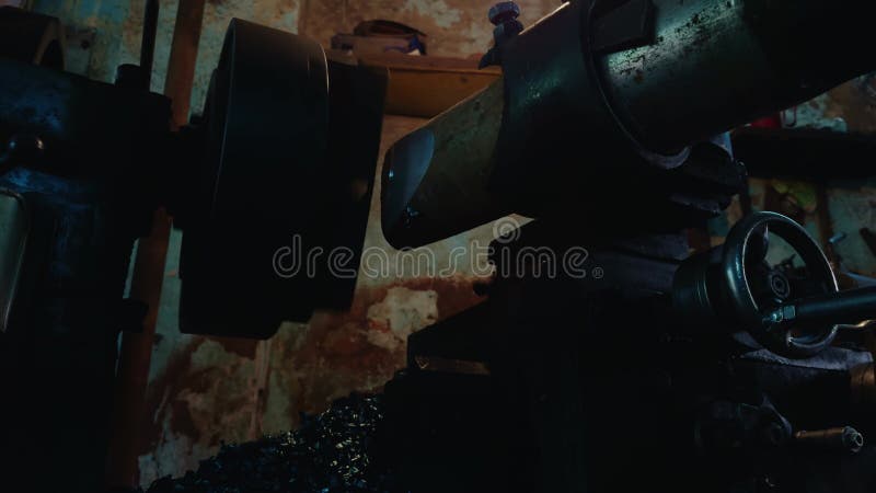 Artisan Using a Lathe Machine in a Rustic Workshop with Tools on the ...