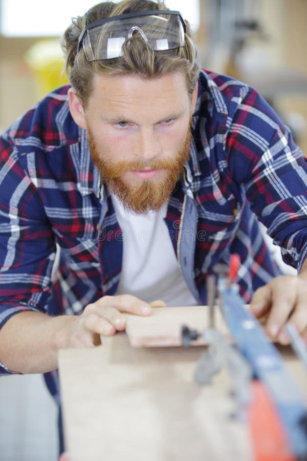 Artisan Working at Carpentry Workshop Cutting Wood Stock Image - Image ...
