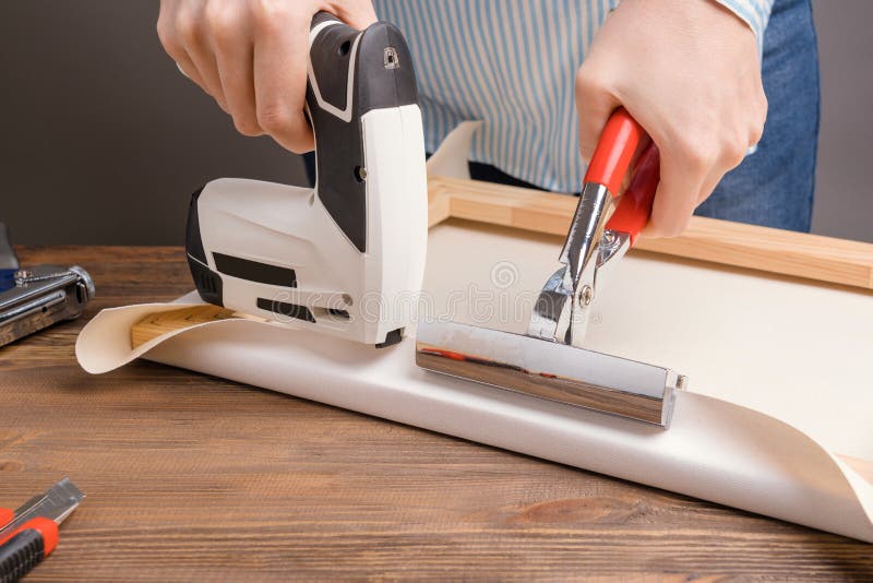 The Artisans Hands Pull the Canvas Onto a Wooden Stretcher with Tongs ...