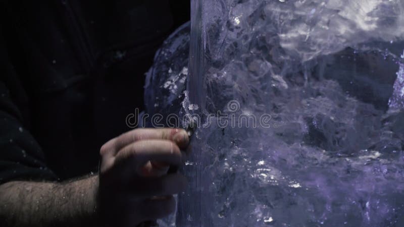Shaping an Ice Sculpture Using a Chisel, Professional Artist at Work ...