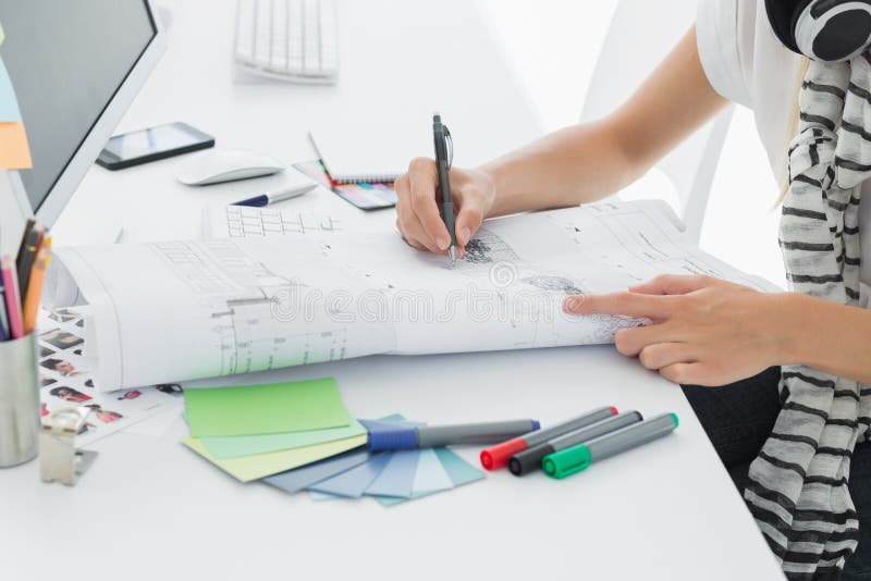 Artist Drawing Something on Paper with Pen at Office Stock Photo ...