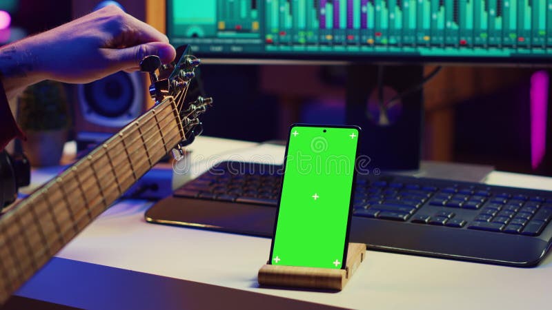 Artist Learning To Tune His Acoustic Guitar with App Tutorial Stock ...