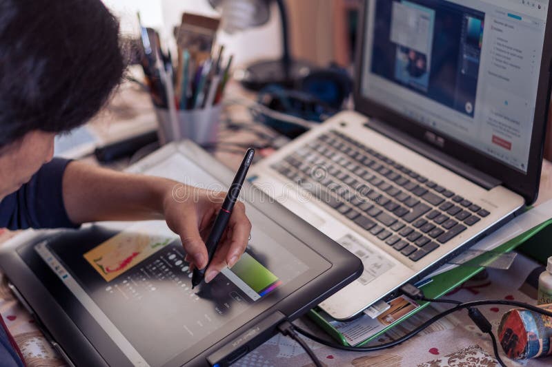 An Artist Uses a Wacom Tablet To Draw Comic Characters. the Image ...