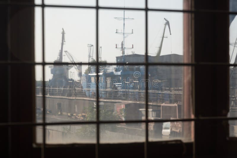 Artistic Blur on a Lattice Window with a View of the Loading of Ships ...