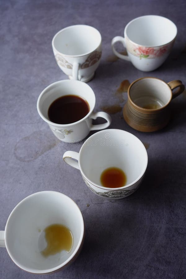 A Diverse Collection of Empty and Stained Coffee Cups Sitting on a ...