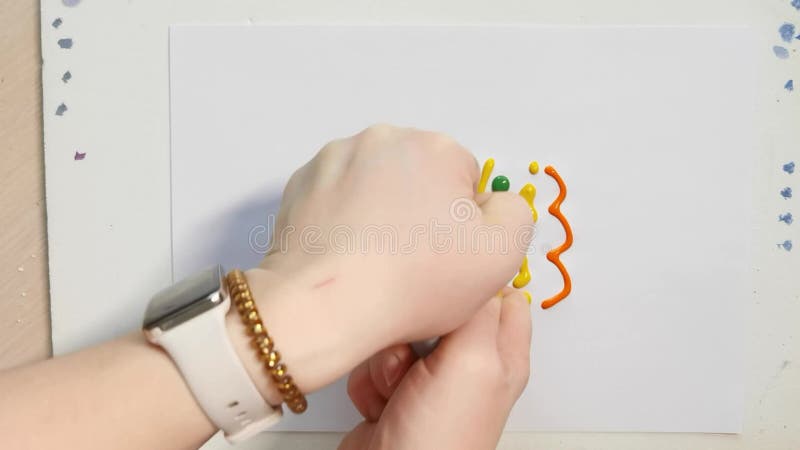 Artistic Hand Dispensing Toothpaste into Colorful Patterns on White ...