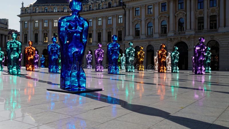 Colorful Illuminated Glass Humanoid Sculptures Displayed in Urban ...