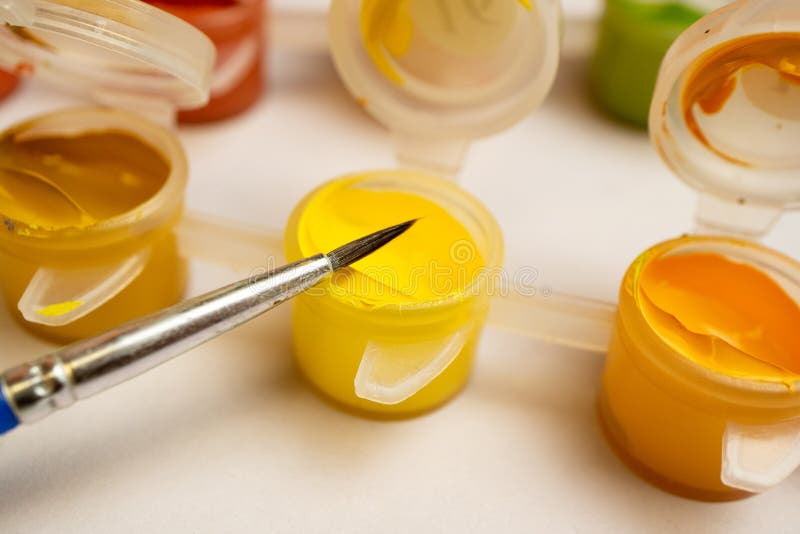 A Lot of Containers with Paint in a Row on Them is a Paintbrush, the ...