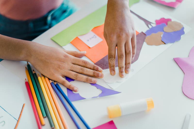 Hands Working on a Creative Craft Project with Colorful Paper and ...