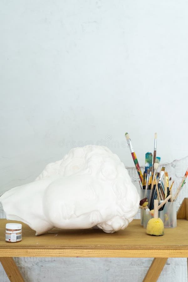 An Artistic Workspace that Showcases a Bust Along with a Range of ...