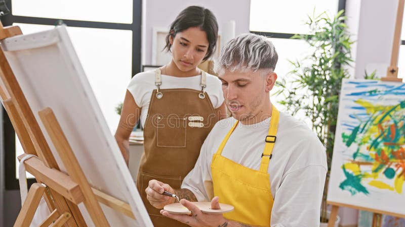 Artists Couple Collaborating in a Bright Studio with Easels and ...