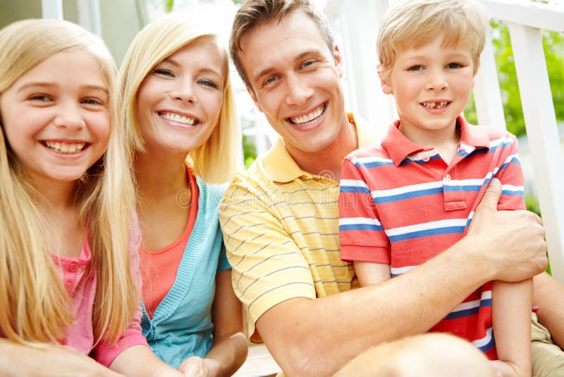 As Close As Family Can Be. a Young Family of Four Outside. Stock Photo ...