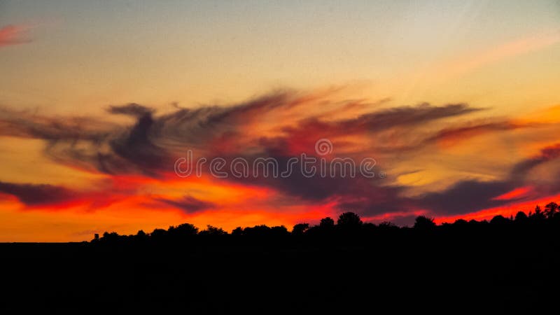Wispy clouds at sunset stock image. Image of orange - 119902489