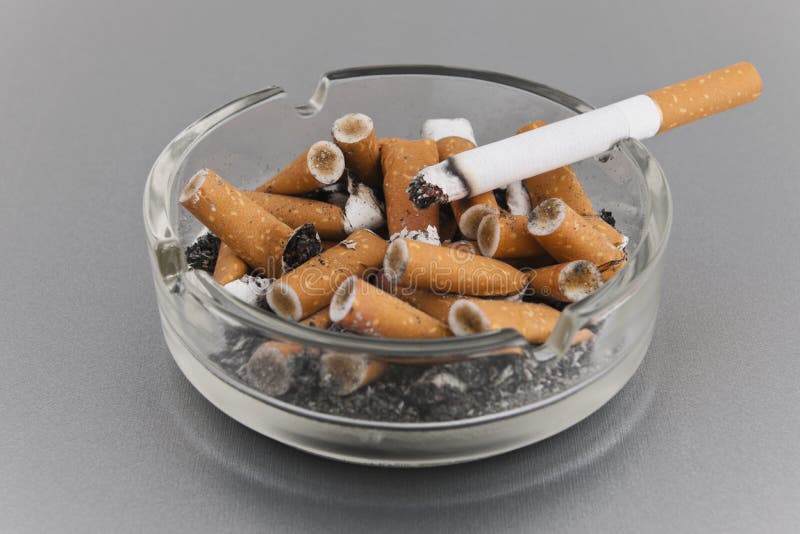 Full ashtray and cigarette stock image. Image of mound - 14248357