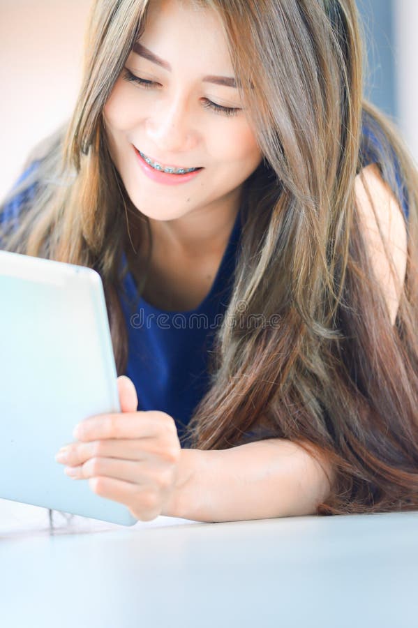 Asia Beautiful Girl with Tablet with Tablet Lying on Floor Stock Photo ...