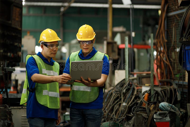 Two Engineers Discussing Work Together in Office Stock Image - Image of ...