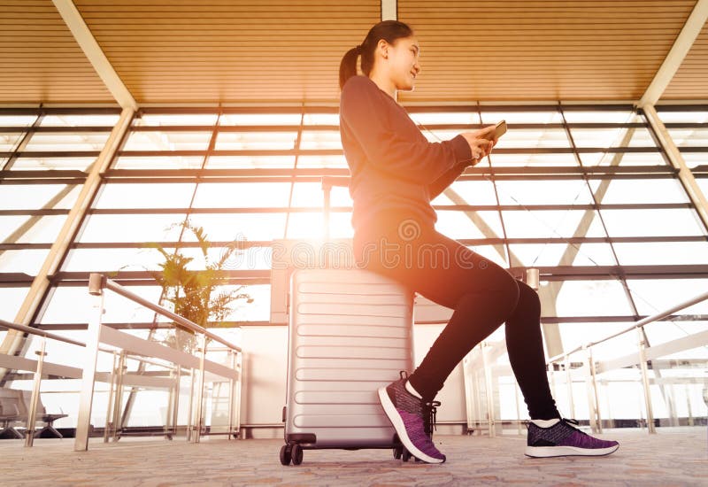 Asia Woman Using Mobile Phone while Waiting Flight in Modern Terminal ...