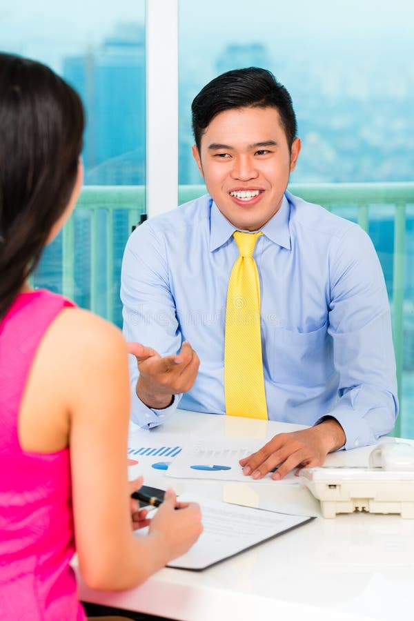 Asian advisor with client stock photo. Image of investment - 44693504