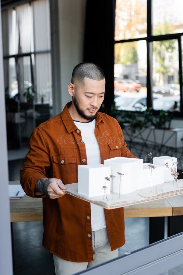 Asian Architect Holding House Models while Stock Photo - Image of ...