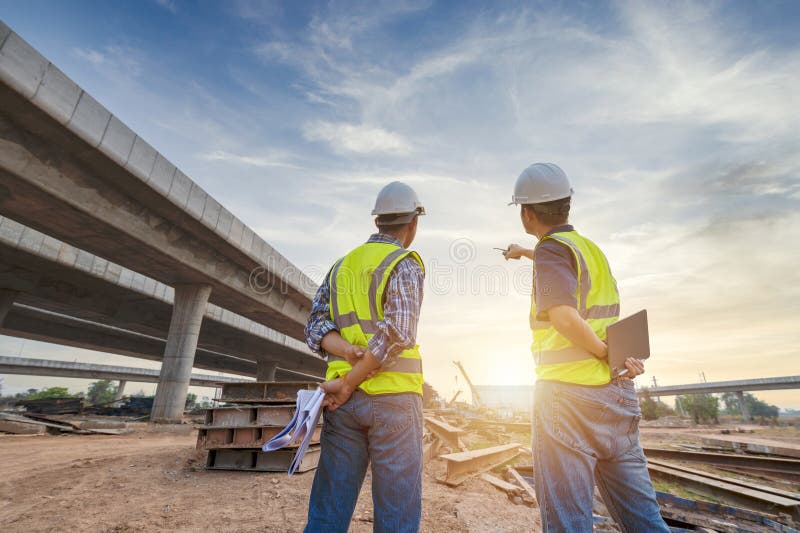 Asian Architect and Mature Supervisors Meeting at Construction Site ...