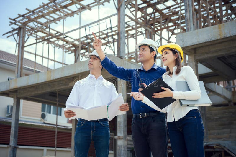 Asian Architector and Engineers Team with Draft Plan of Building and ...