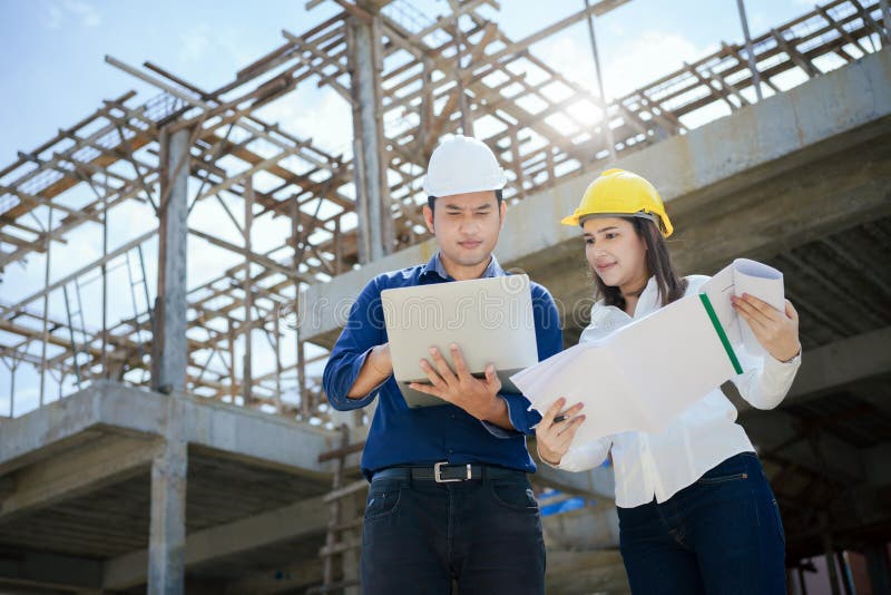 Asian Architector and Engineers Team with Draft Plan of Building and ...