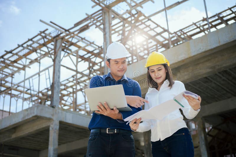 Asian Architector and Engineers Team with Draft Plan of Building and ...