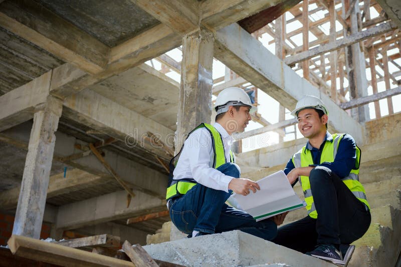 Asian Architector and Engineers Team with Draft Plan of Building and ...