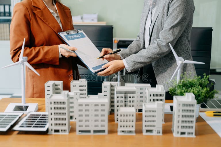 Asian Architects and Developers in a Modern Office Collaborate Using Building Models and Digital ...