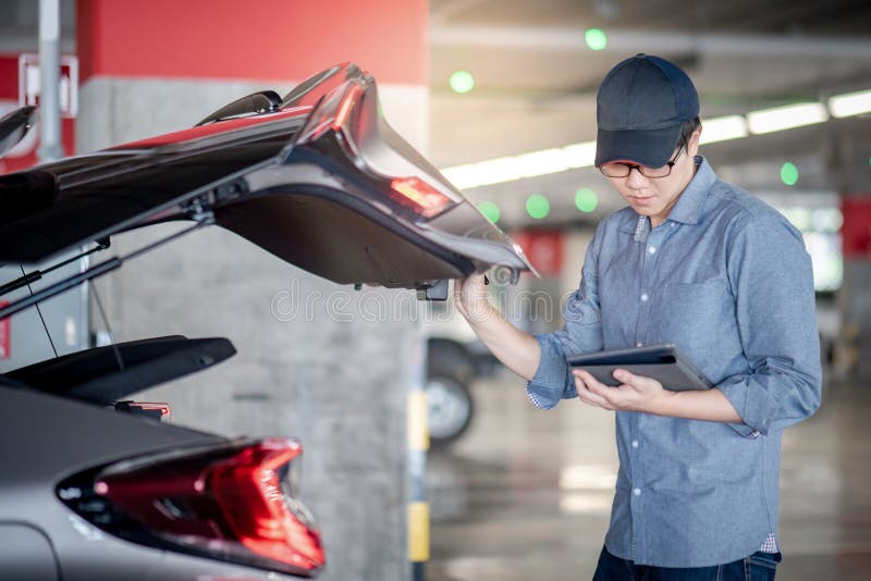 Asian Auto Mechanic Checking the Car Using Tablet Stock Photo - Image ...