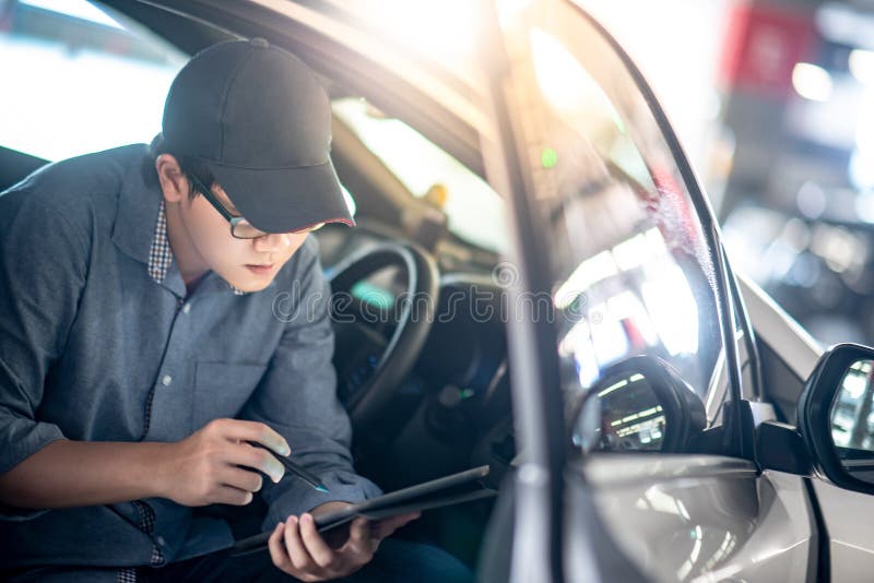 Asian Auto Mechanic Checking the Car Using Tablet Stock Photo - Image ...