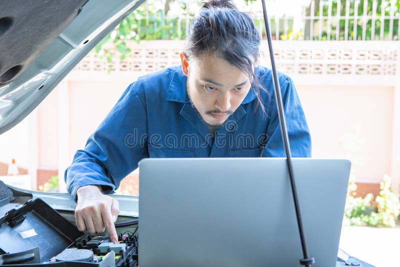 Asian Auto Mechanic Testing Car ECU with Laptop Stock Photo - Image of ...