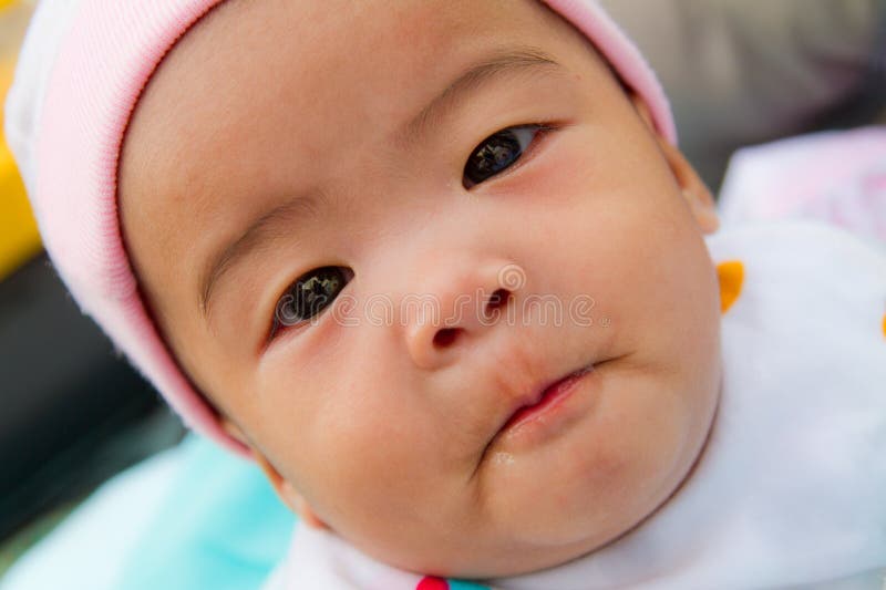 Asian baby bite her lip stock image. Image of child, childhood - 23450081