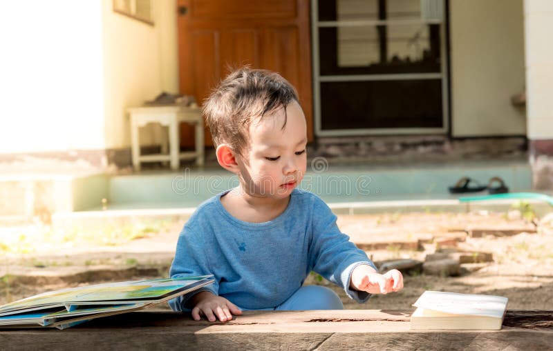Asian Baby Boy Reading Tale Book Alone at Outdoor Stock Photo - Image ...