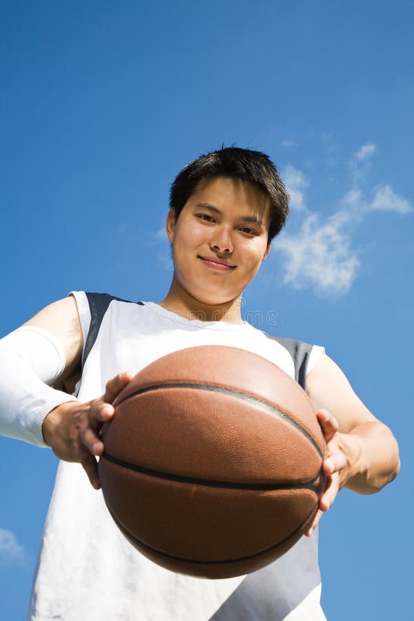 Asian Man Basketball Player Holding the Ball with an Excited Expression ...