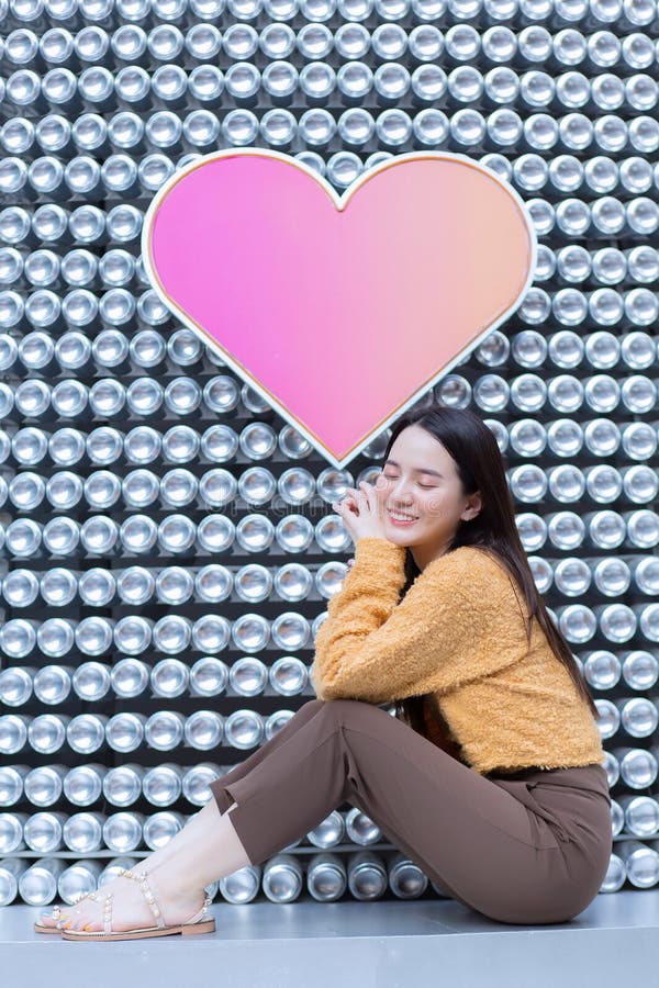 Asian Beautiful Woman With Long Hair Is Sitting And Closing Her Eyes In