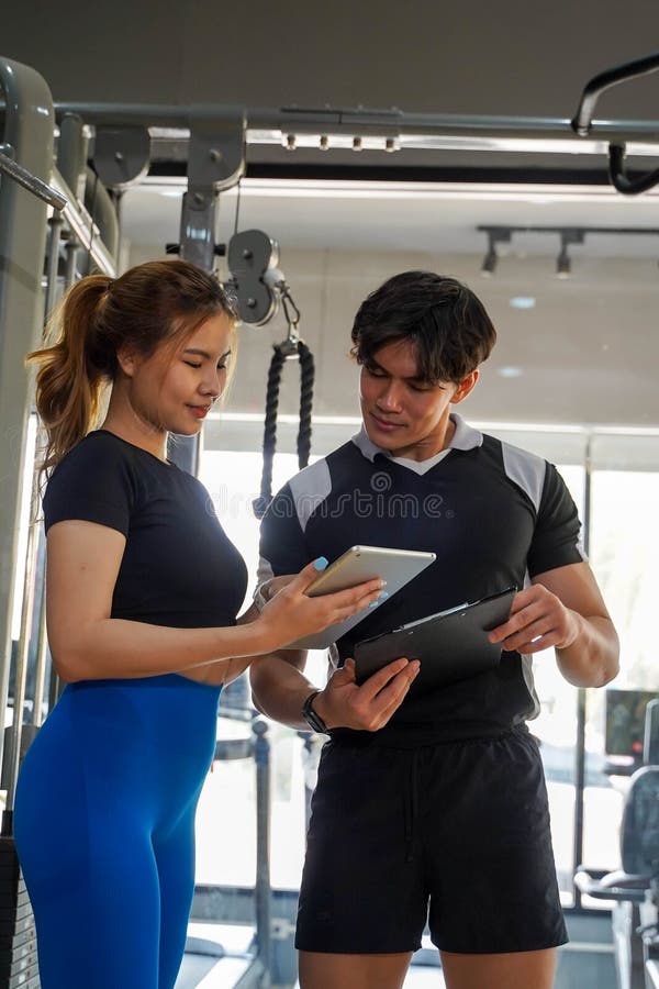 Asian Beautiful Young Female Holding Tablet Computer with Fitness ...