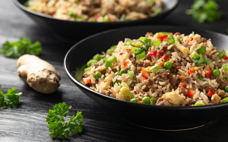 Asian Beef Fried Rice with Eggs and Vegetables in Black Bowl Stock ...