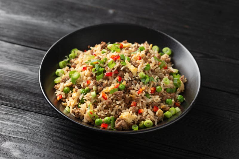 Asian Beef Fried Rice with Eggs and Vegetables in Black Bowl Stock ...
