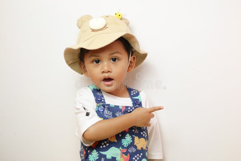 Asian Boy with Cute Cap Pointing Side in White Background Stock Photo ...