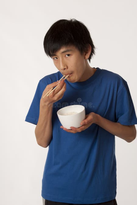 Asian boy eating rice stock photo. Image of teenager - 19431834