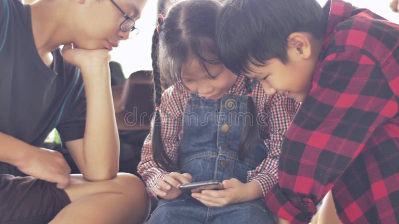 Asian Boy and Girl Using Laptop Computer Together. Stock Video - Video ...
