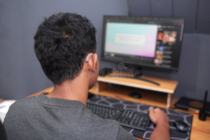 Asian Boy with Hearing Aid Device Using Computer Stock Image - Image of ...
