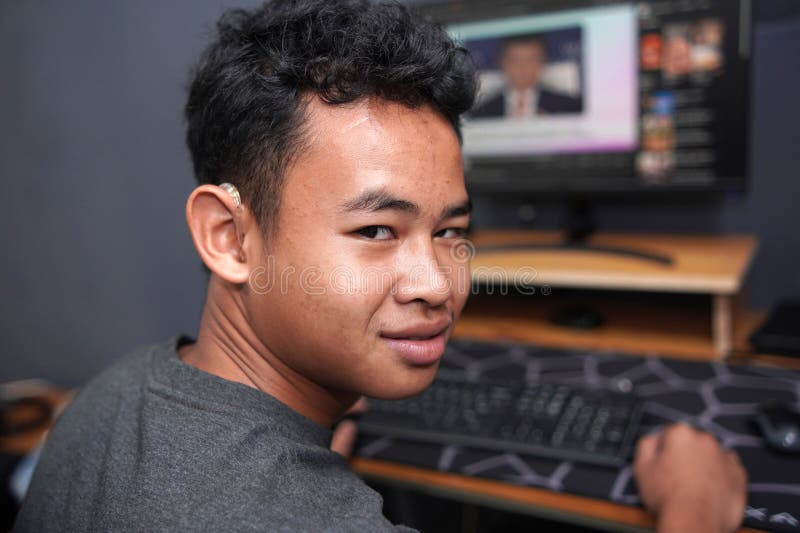Asian Boy with Hearing Aid Device Using Computer Stock Image - Image of ...