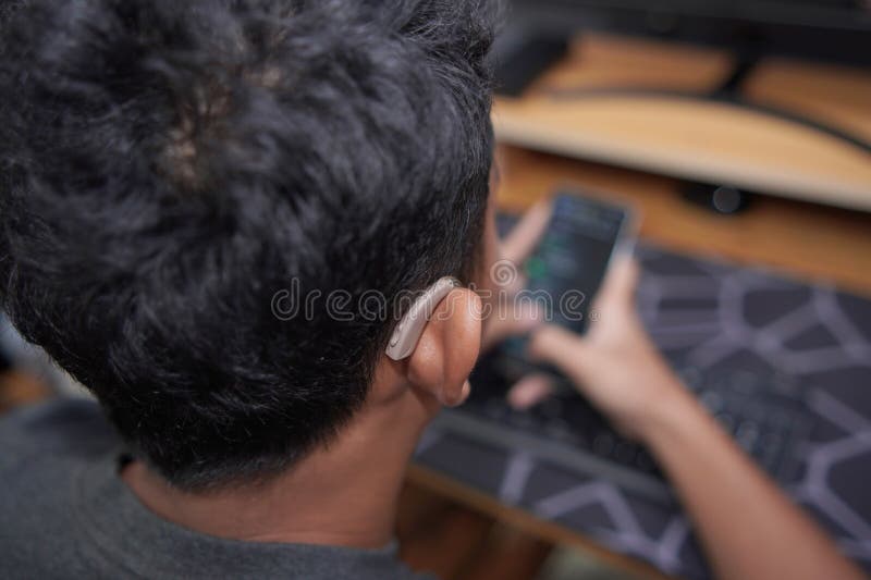 Asian Boy with Hearing Aid Device Using Phone Stock Image - Image of ...