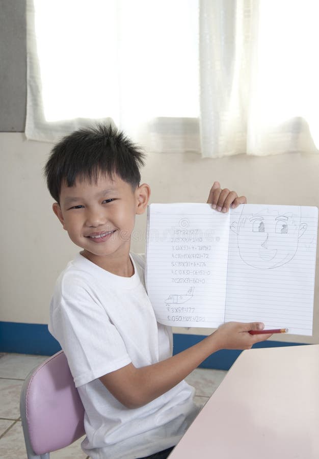 Asian Boy Holding His Home Work in Class Room Stock Image - Image of ...