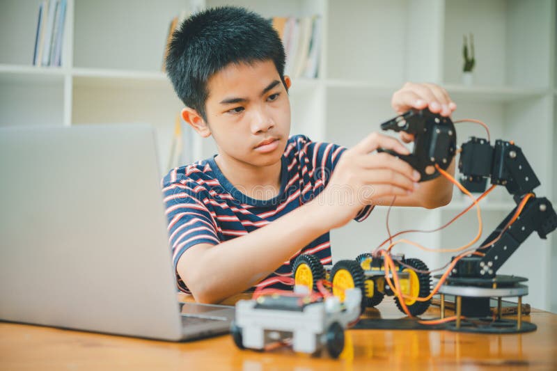 Asian Boy Learning and Studying the Work of Technology Robots ...