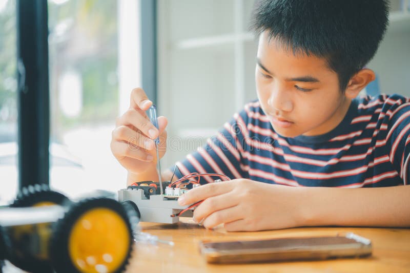Asian Boy Learning and Studying the Work of Technology Robots ...